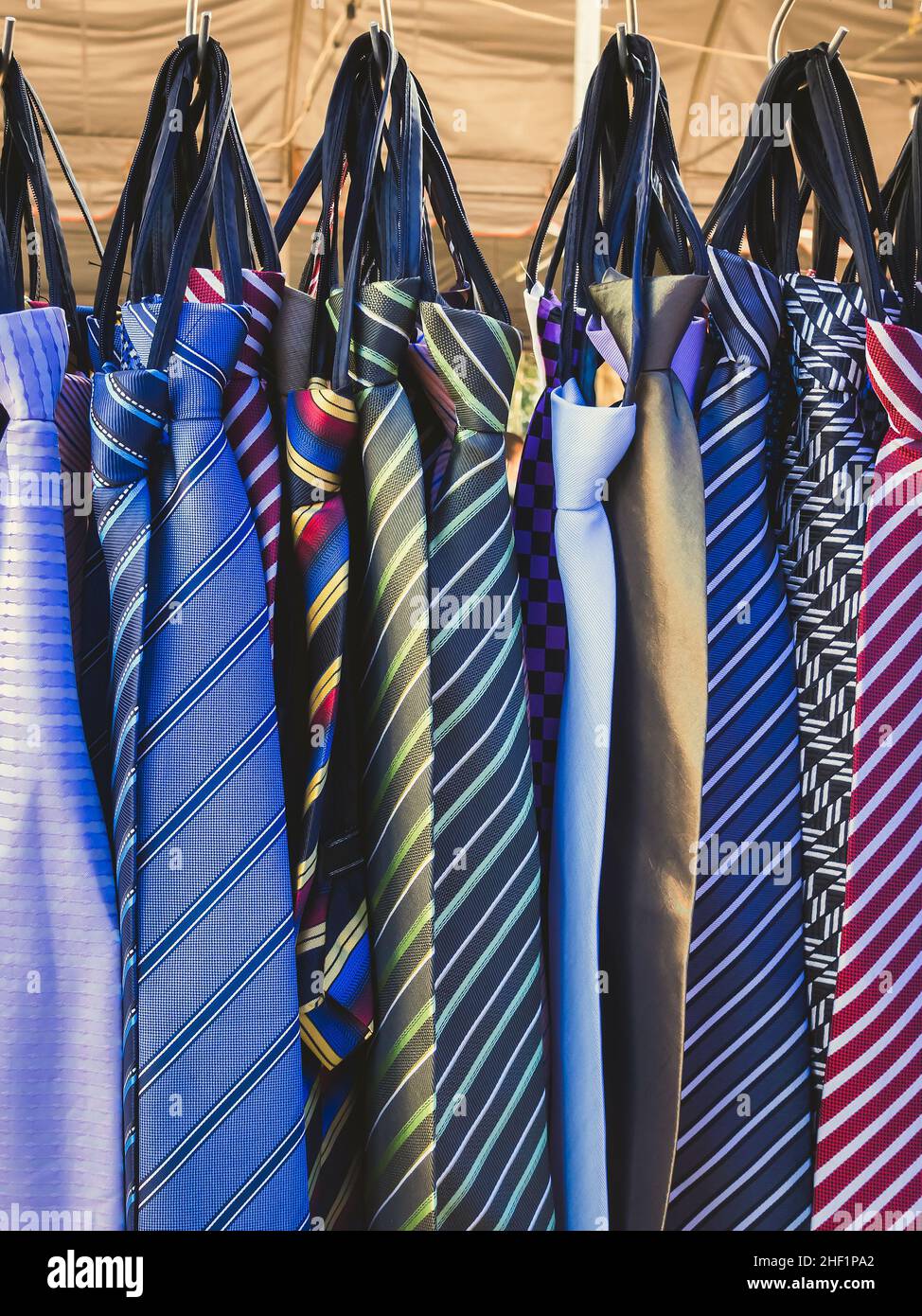 Large selection of colorful neckties hanging in the sale on the street ...