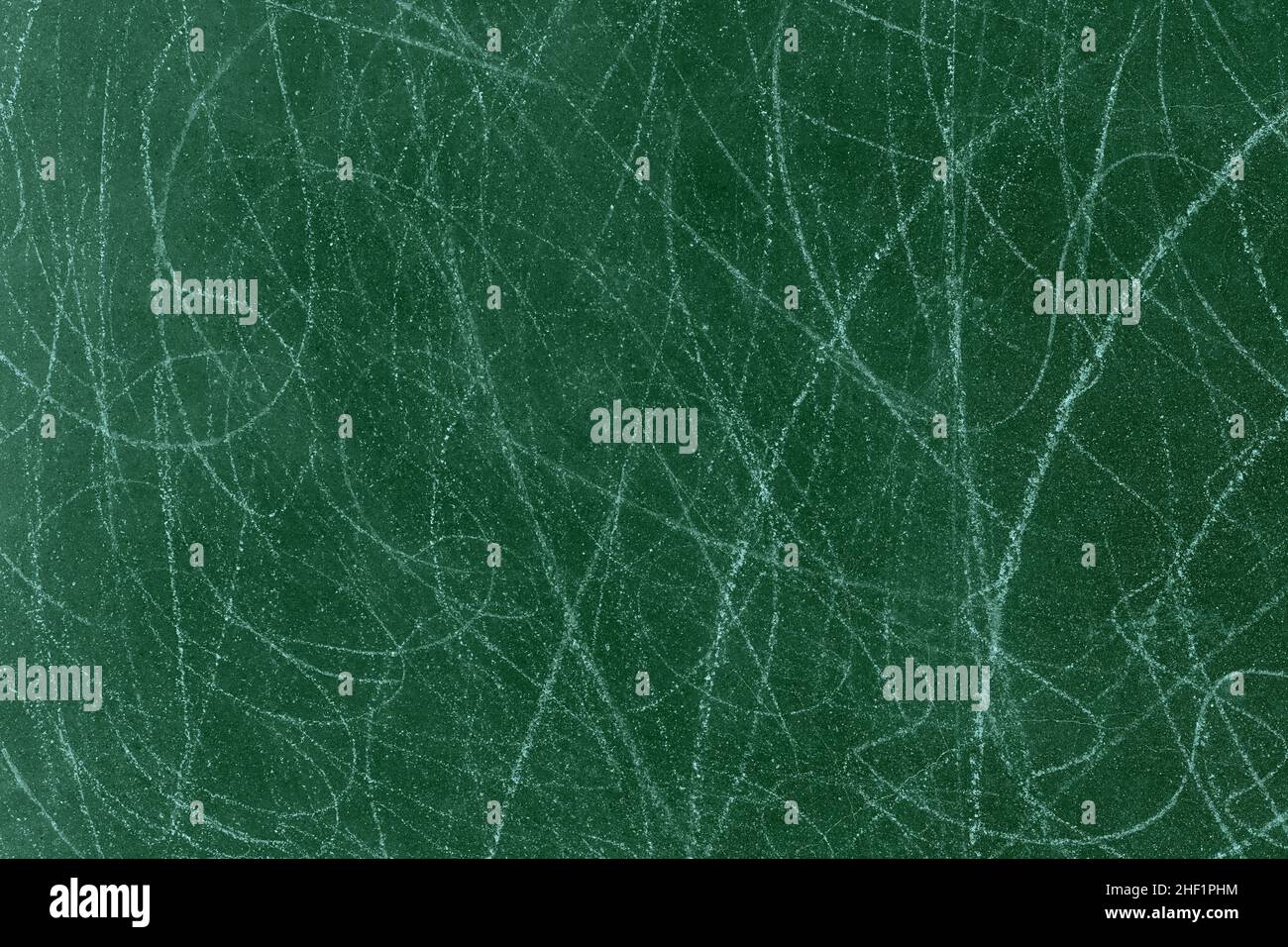 Dark green color rough concrete wall surface with random white scratch ...