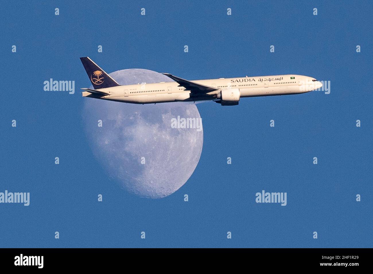 Saudi Arabian Airlines A350-900 plane passes the waxing moon above ...