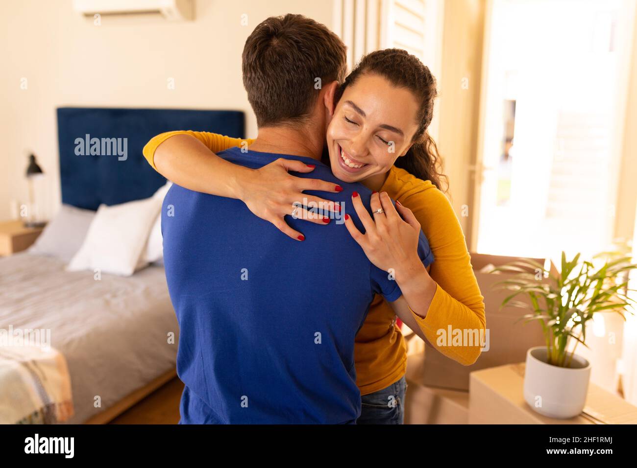 Caucasian couple hugging each other in the bedroom at home Stock Photo ...