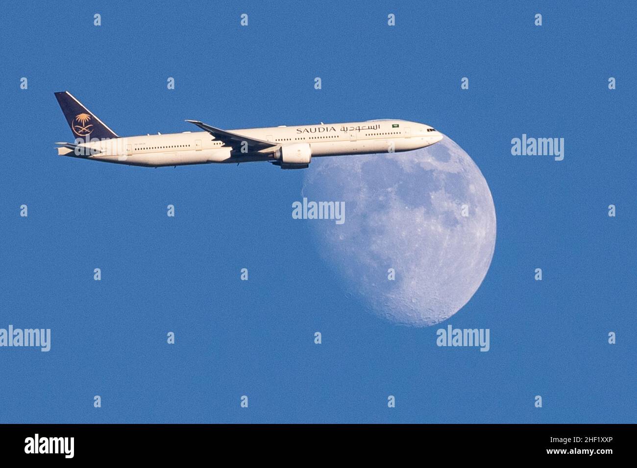 Saudi Arabian Airlines A350-900 plane passes the waxing moon above ...