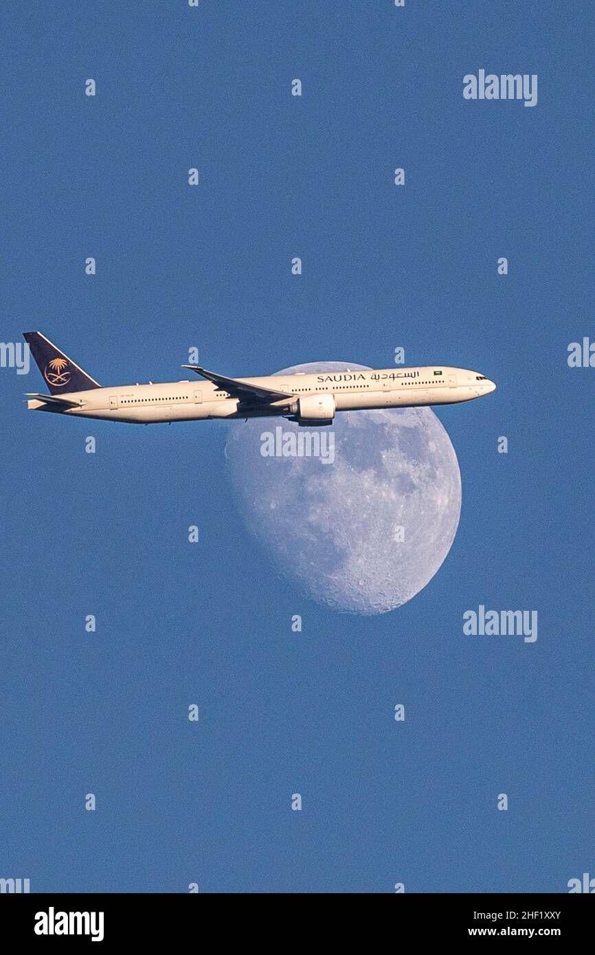 Saudi Arabian Airlines A350-900 plane passes the waxing moon above ...