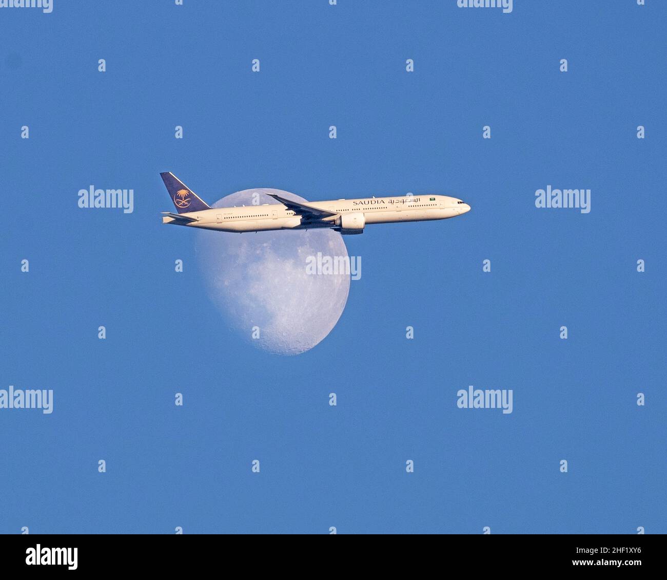 Saudi Arabian Airlines A350-900 plane passes the waxing moon above ...