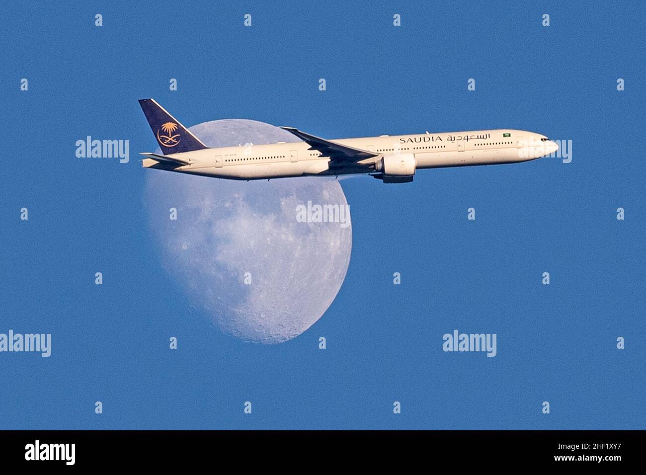 Saudi Arabian Airlines A350-900 plane passes the waxing moon above ...