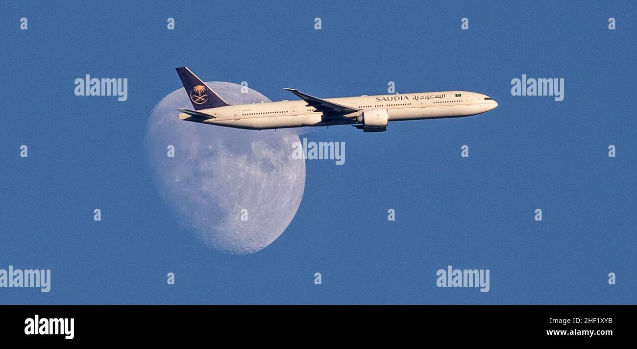 Saudi Arabian Airlines A350-900 plane passes the waxing moon above ...