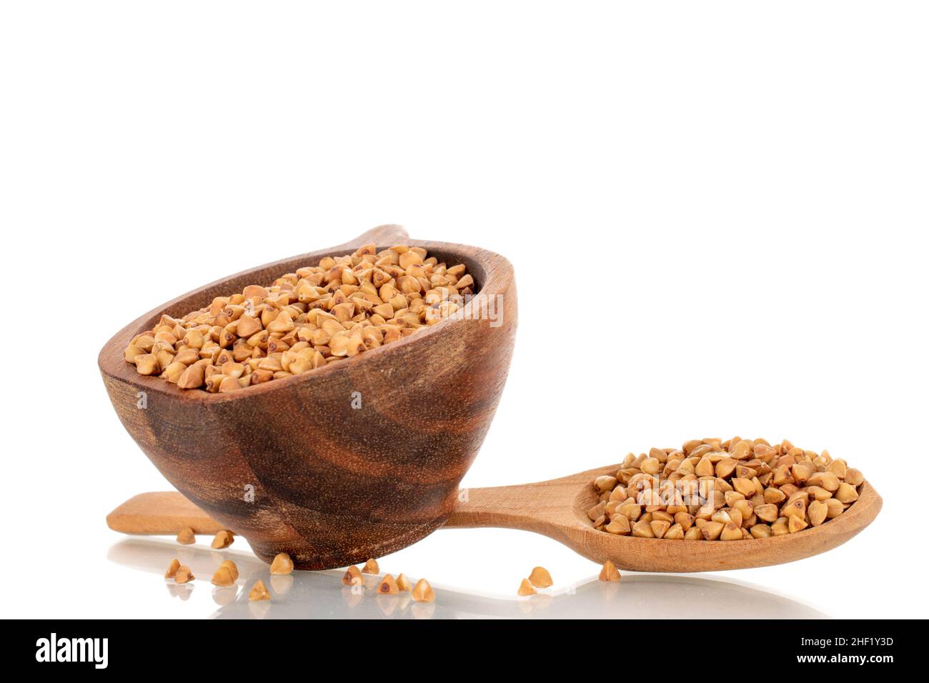 Uncooked organic buckwheat groats with wooden cup and spoon, close-up ...
