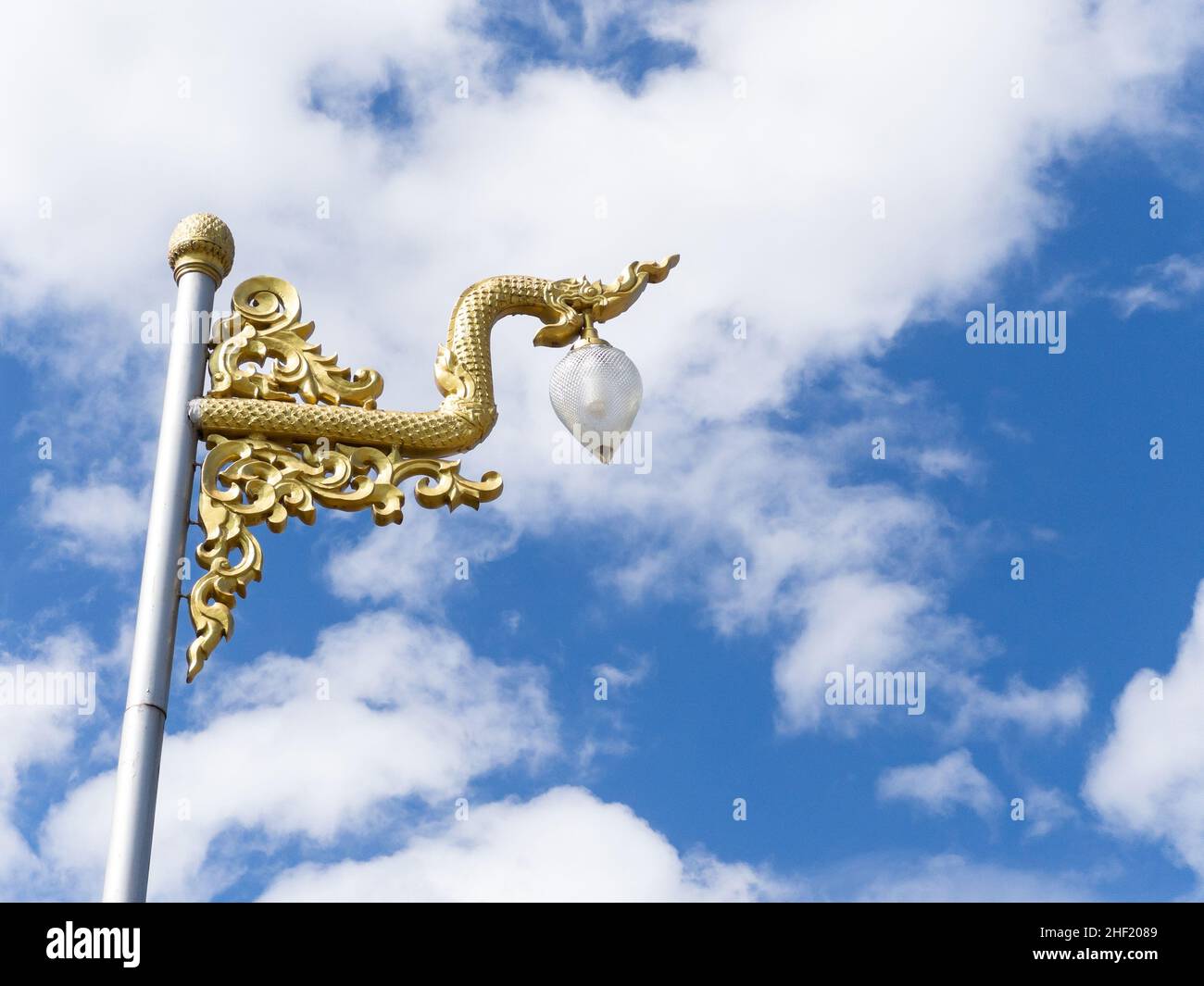 The golden snake statue was adorned on a street light pole in the Thai ...