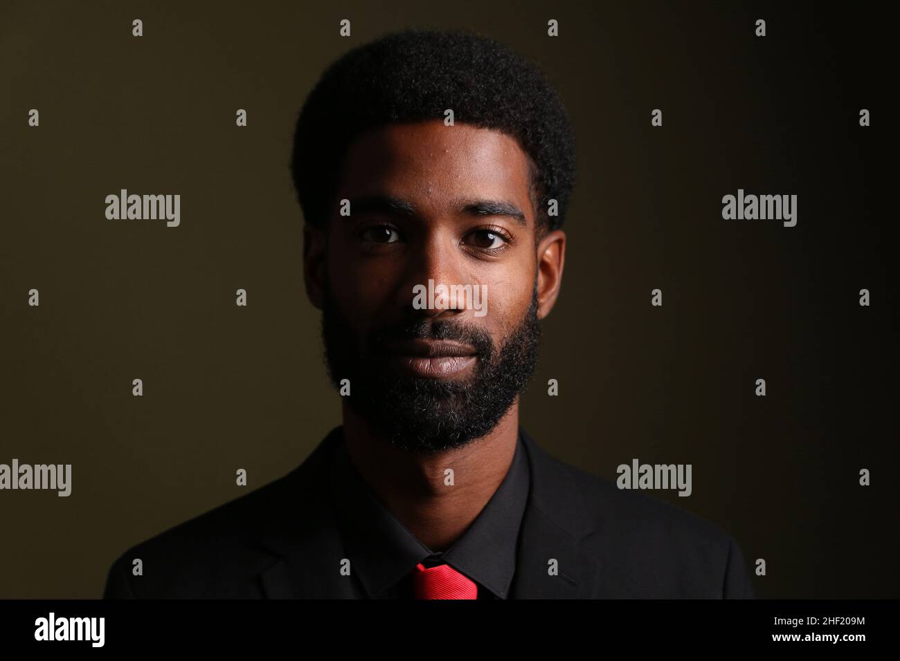Portrait of a beautiful happy man in front of a colored background ...