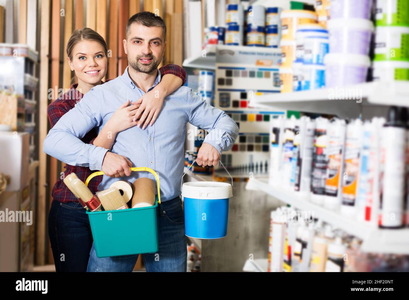 Designers with paint instruments in store Stock Photo - Alamy