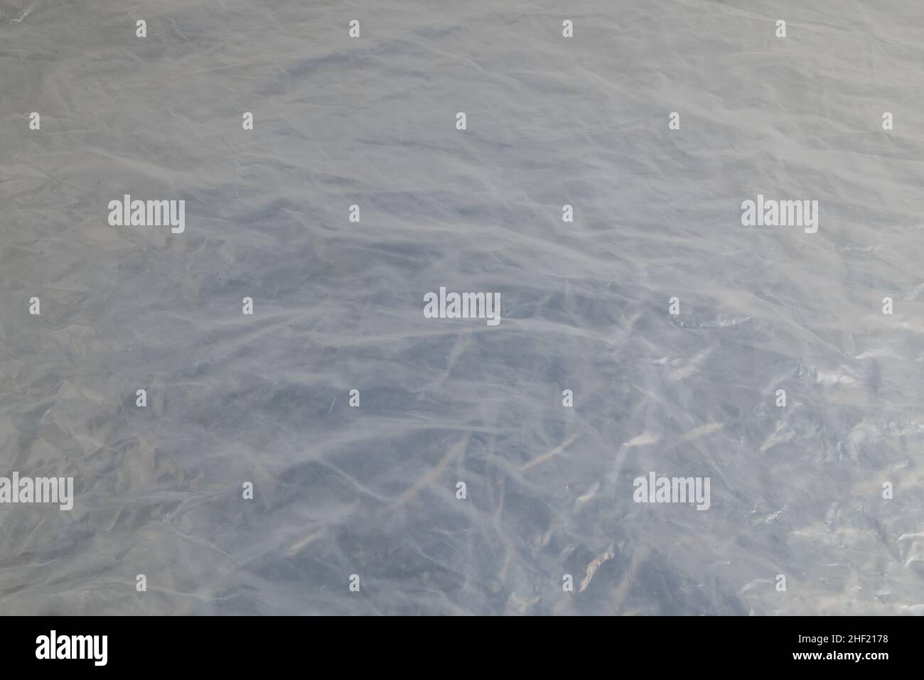 full frame background of flat crumpled semi-transparent polyethylene ...