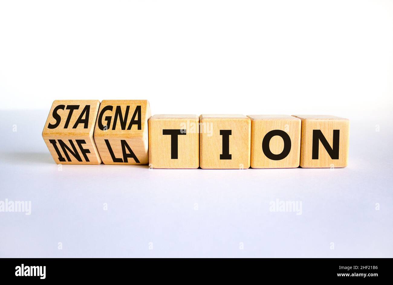 Inflation and stagnation symbol. Turned wooden cubes and changed the ...