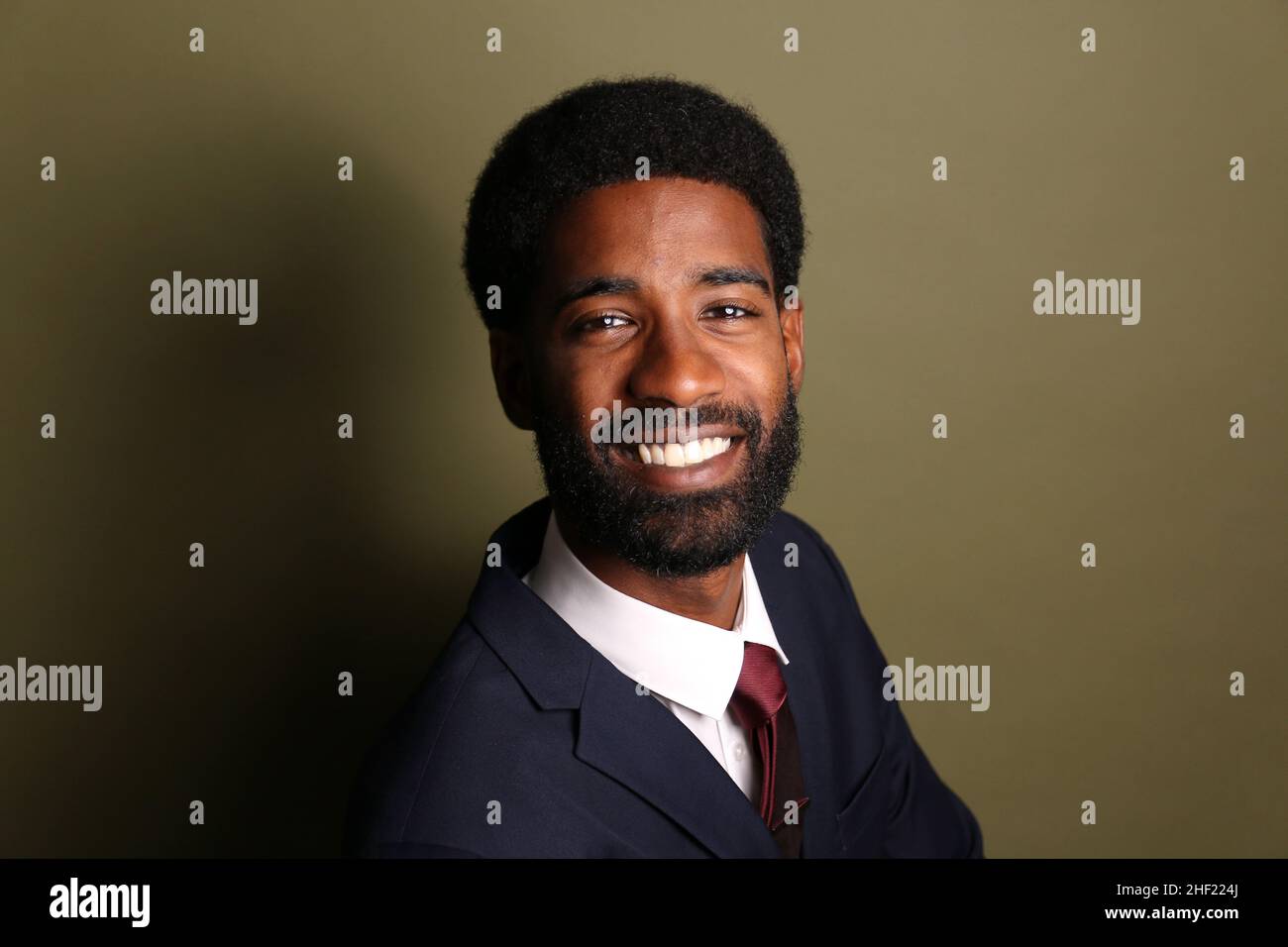 Portrait of a beautiful happy man in front of a colored background ...
