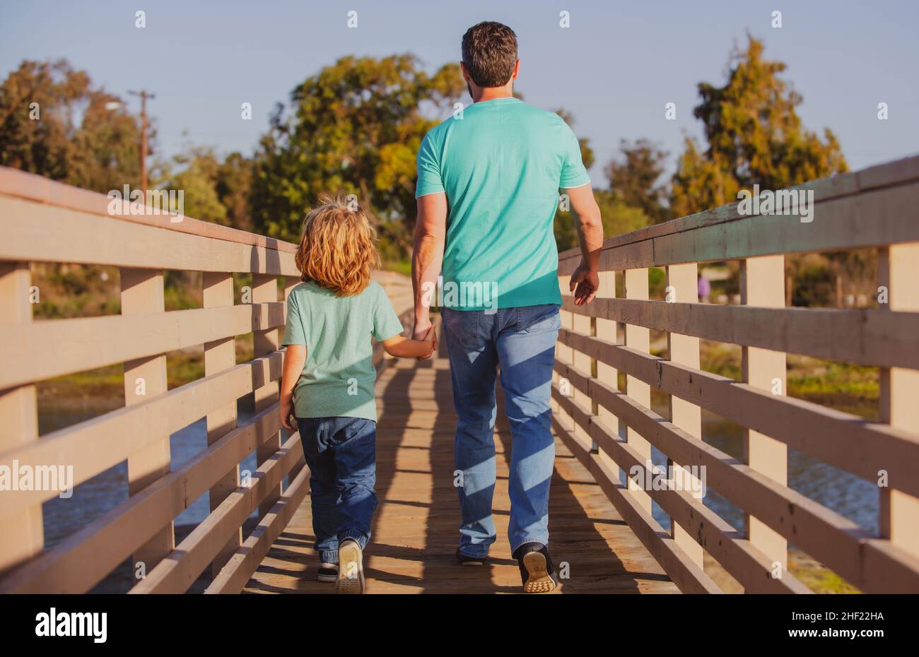Back view of dad and child walking outdoors Stock Photo - Alamy