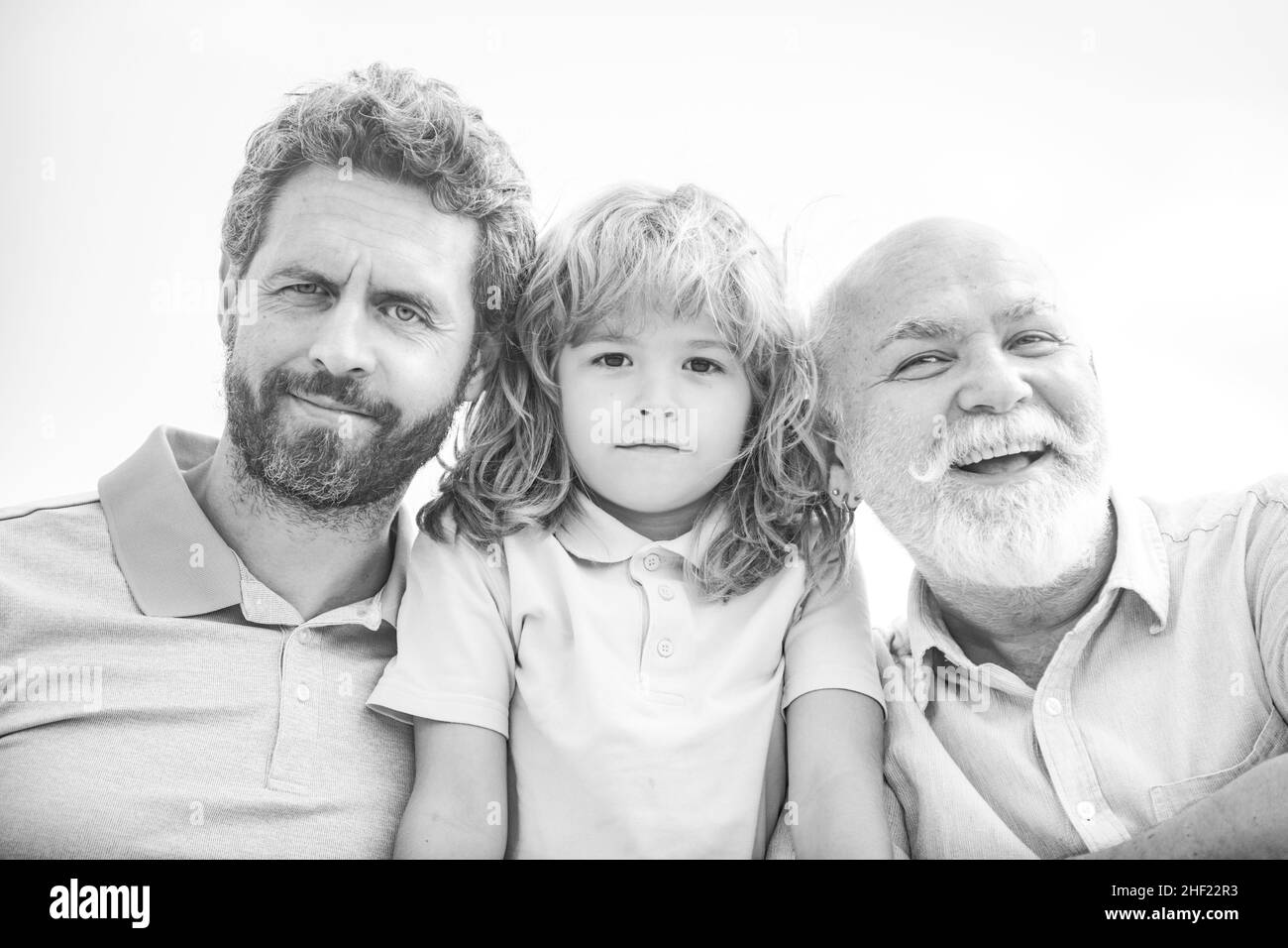 Boy son with father and grandfather, outdoor close up portrait. Fathers ...