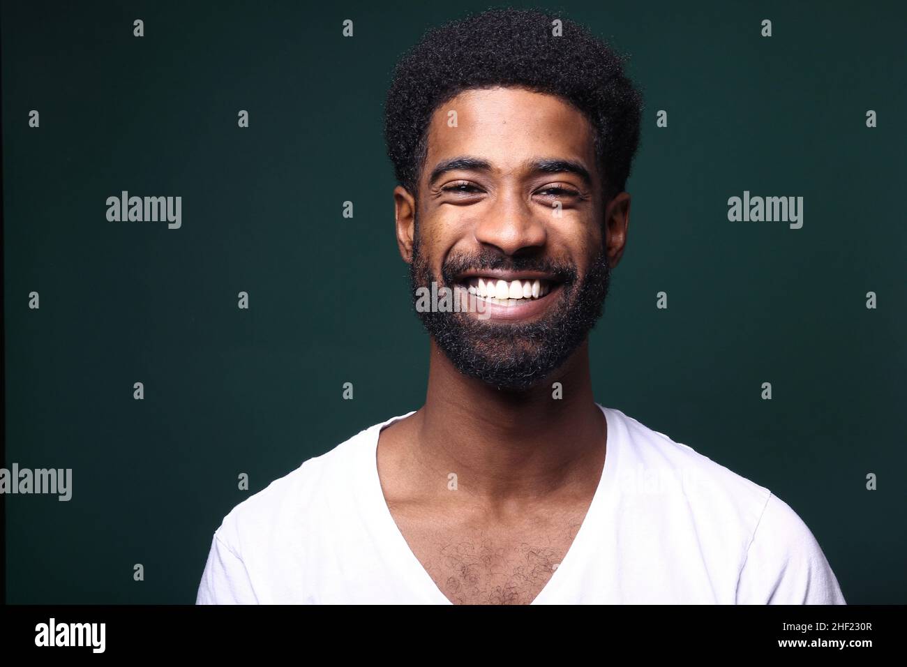 Portrait of a beautiful happy man in front of a colored background ...