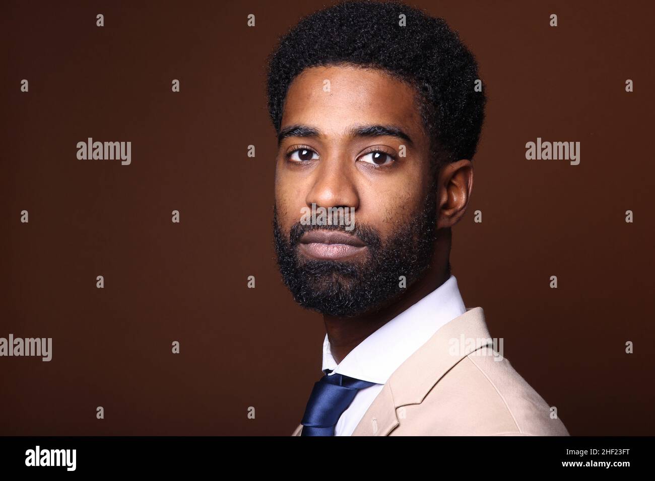 Portrait of a beautiful happy man in front of a colored background ...