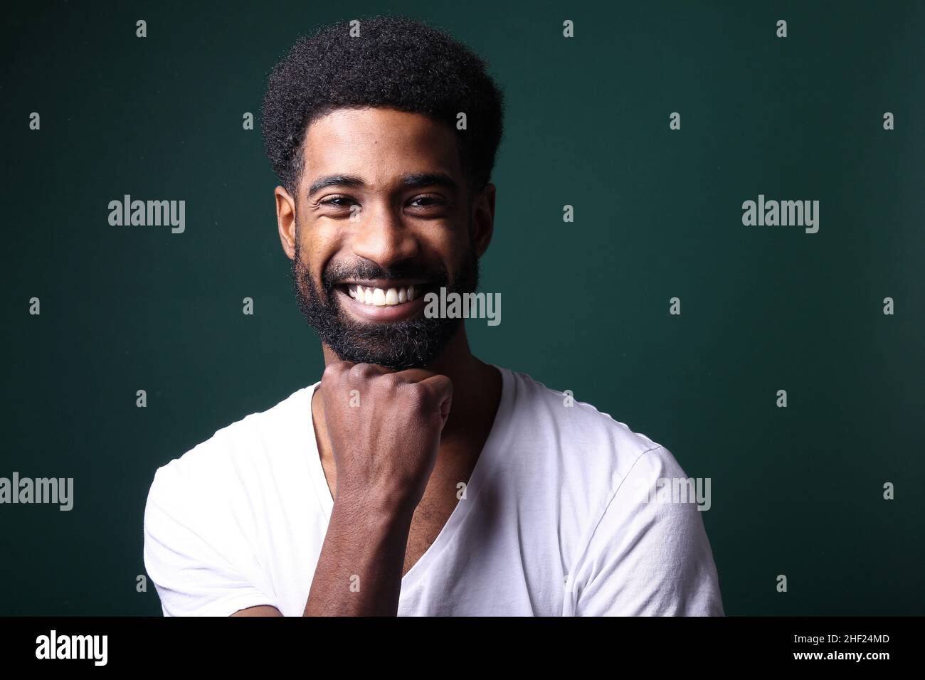 Portrait of a beautiful happy man in front of a colored background ...