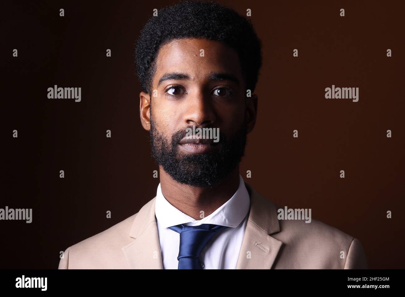 Portrait of a beautiful happy man in front of a colored background ...