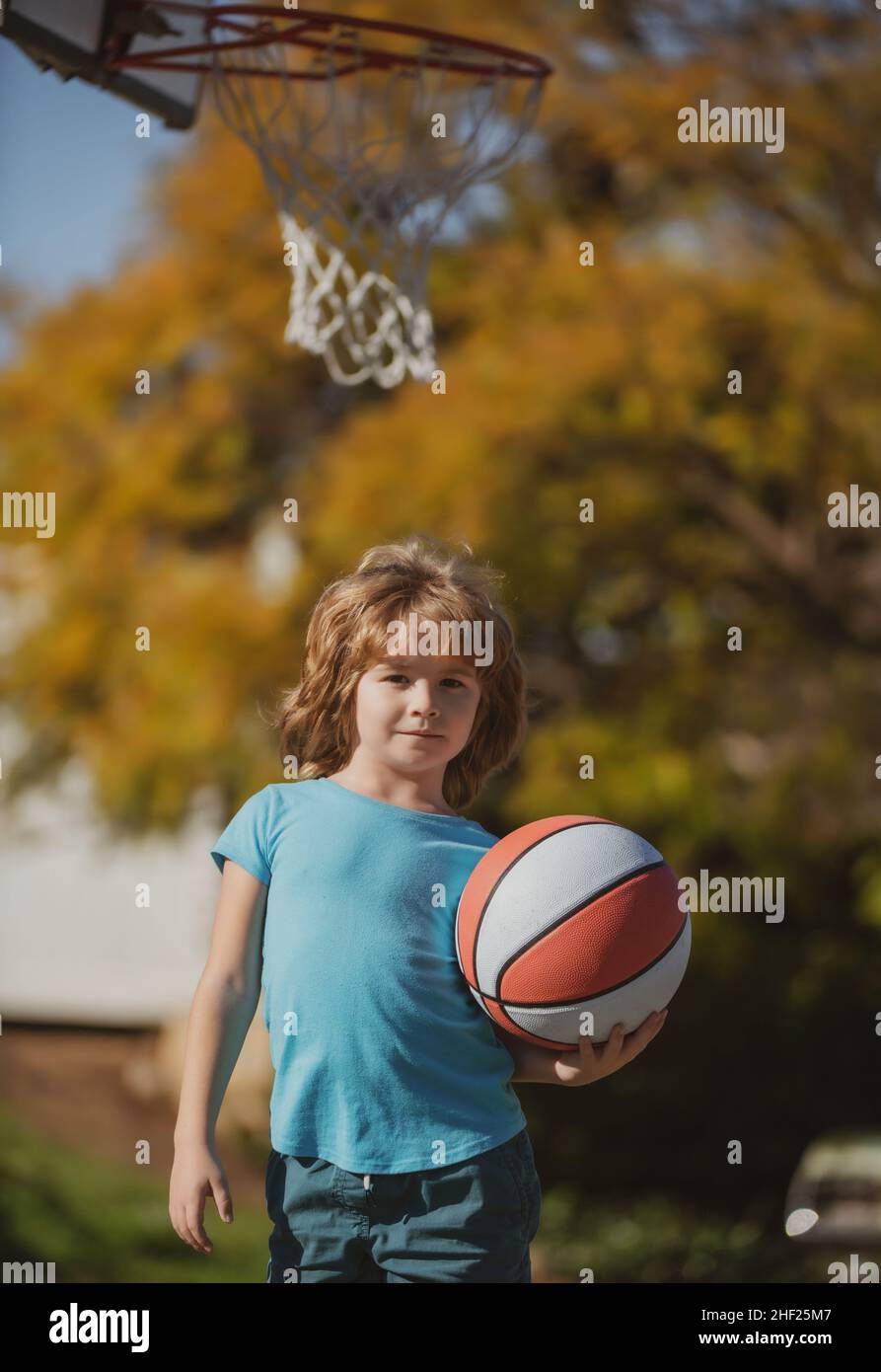 Cute little boy holding a basket ball trying make a score. Sport for ... Cute little boy holding a basket ball trying make a score. Sport for ...