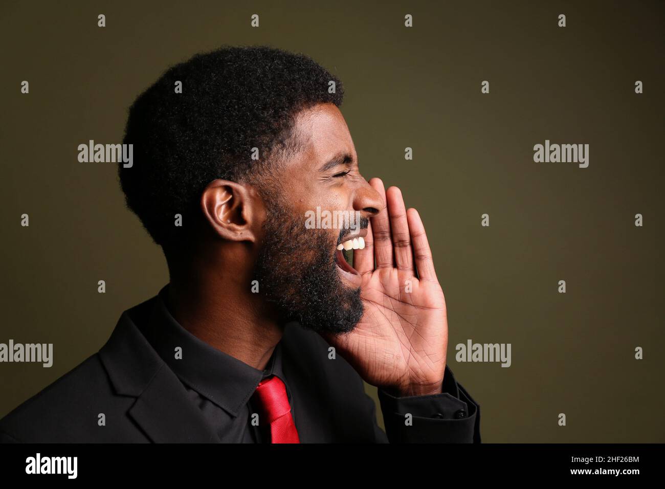 Portrait of a beautiful happy man in front of a colored background ...