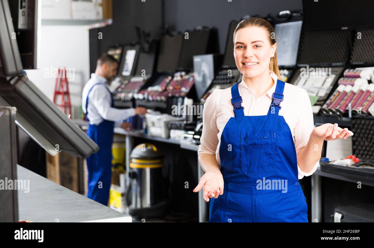 Female mechanic welcoming in car painting workshop Stock Photo - Alamy
