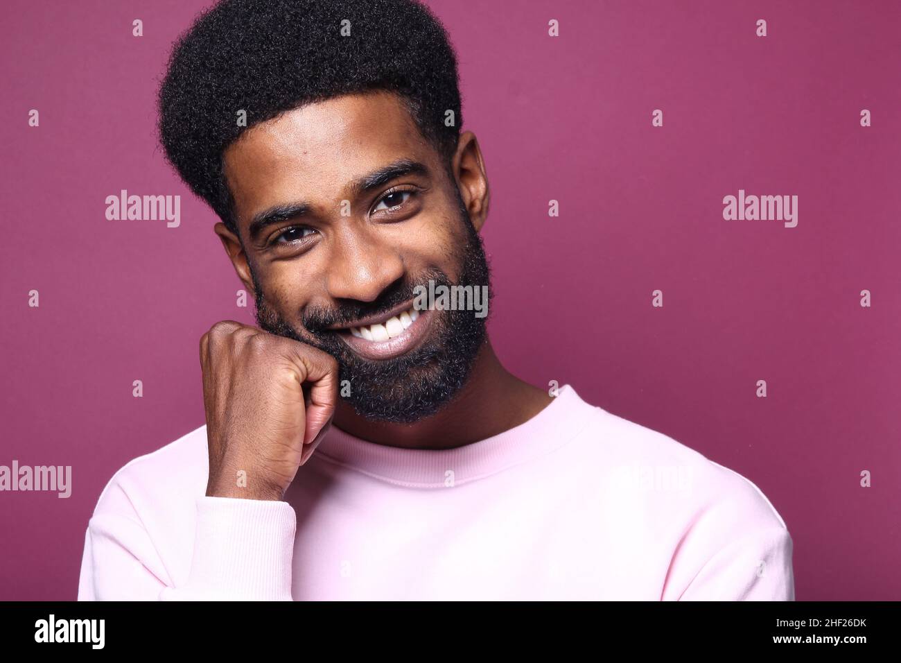 Portrait of a beautiful happy man in front of a colored background ...