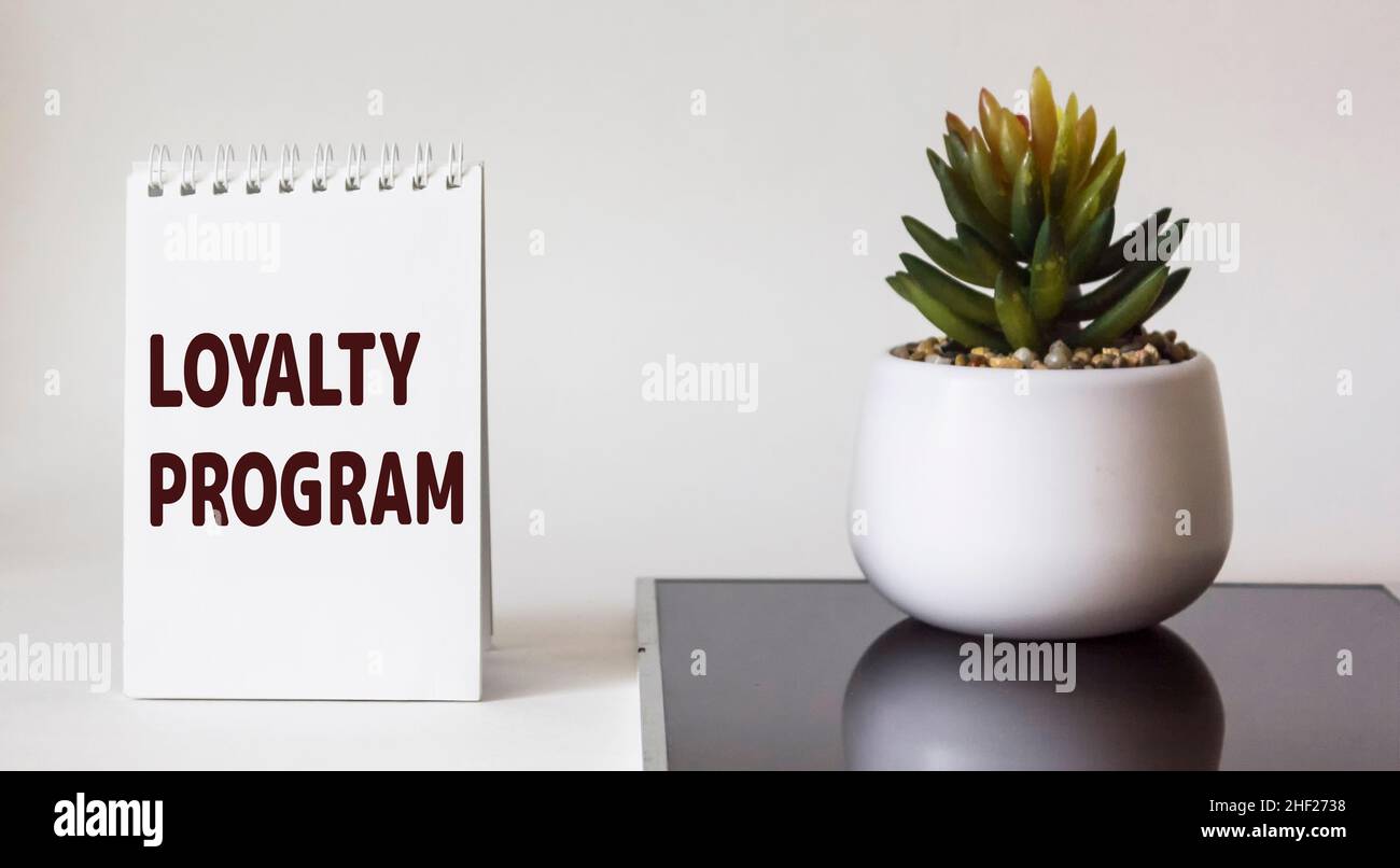 Notepad with word Loyalty program on white background Stock Photo - Alamy