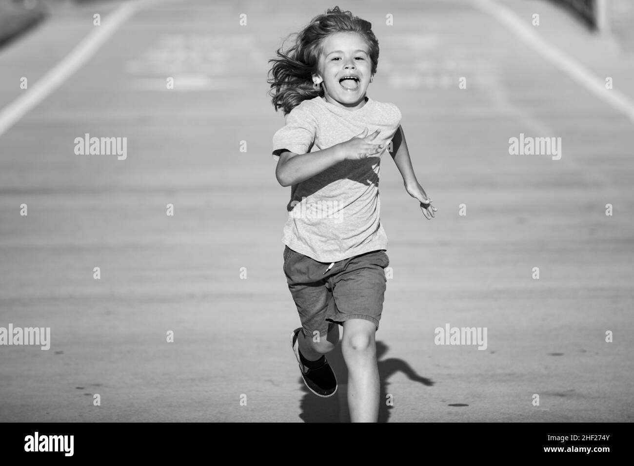 Cheerful boy running to school. Kids run race Stock Photo - Alamy