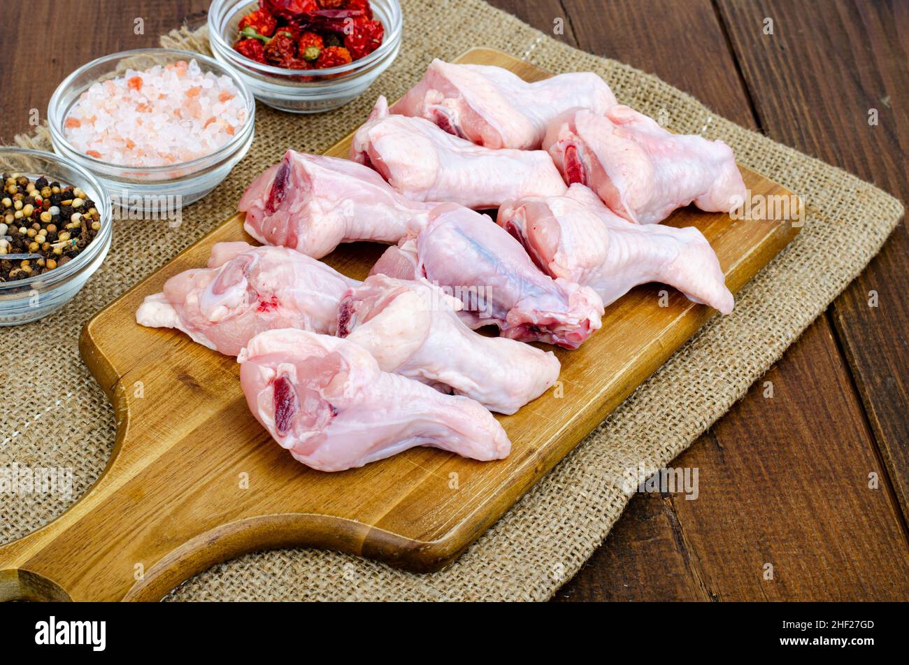 Raw chicken wings with bone and skin on wooden cutting board. Photo ...
