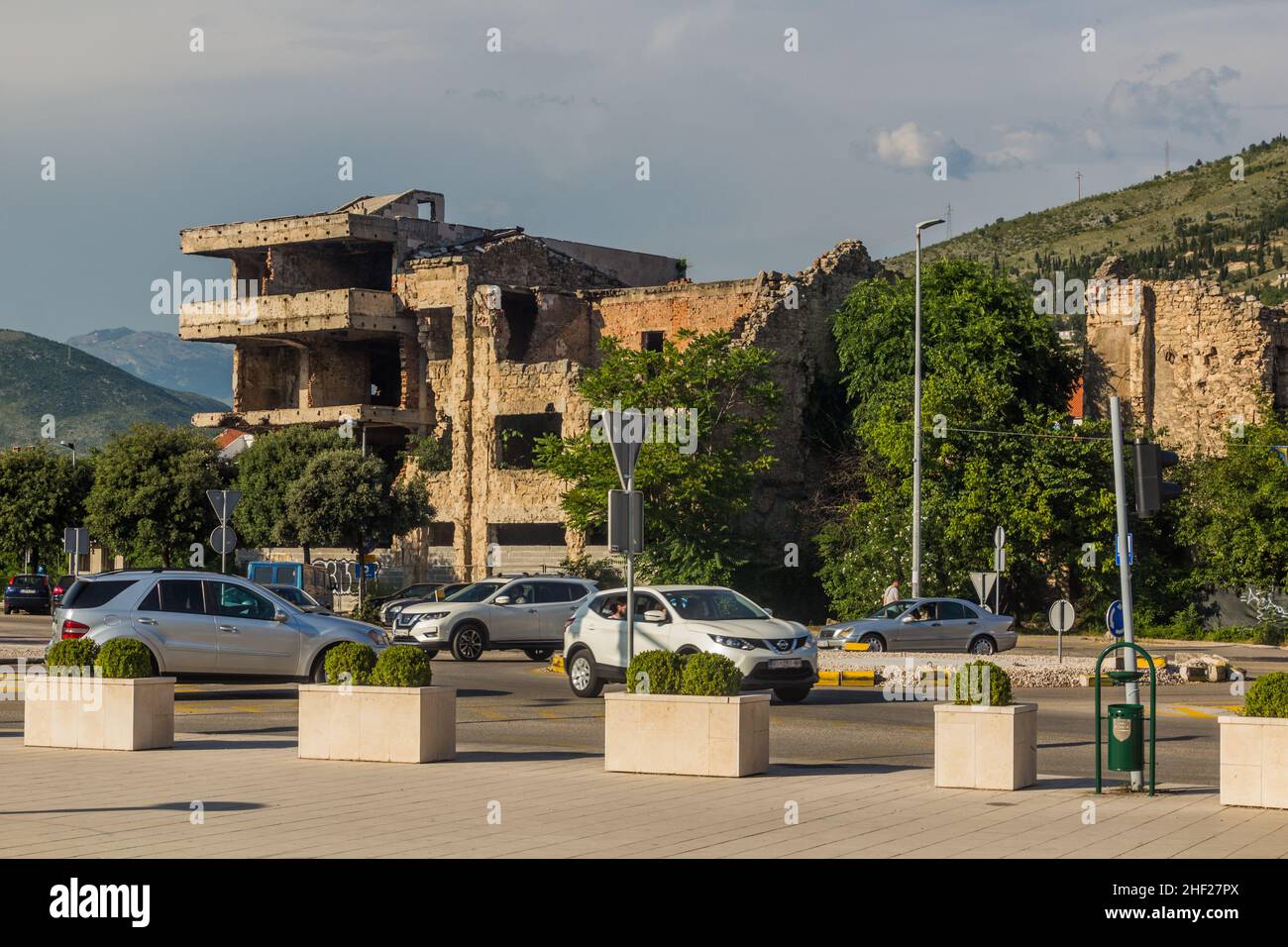 MOSTAR, BOSNIA AND HERZEGOVINA - JUNE 10, 2019: War damaged buildings ...
