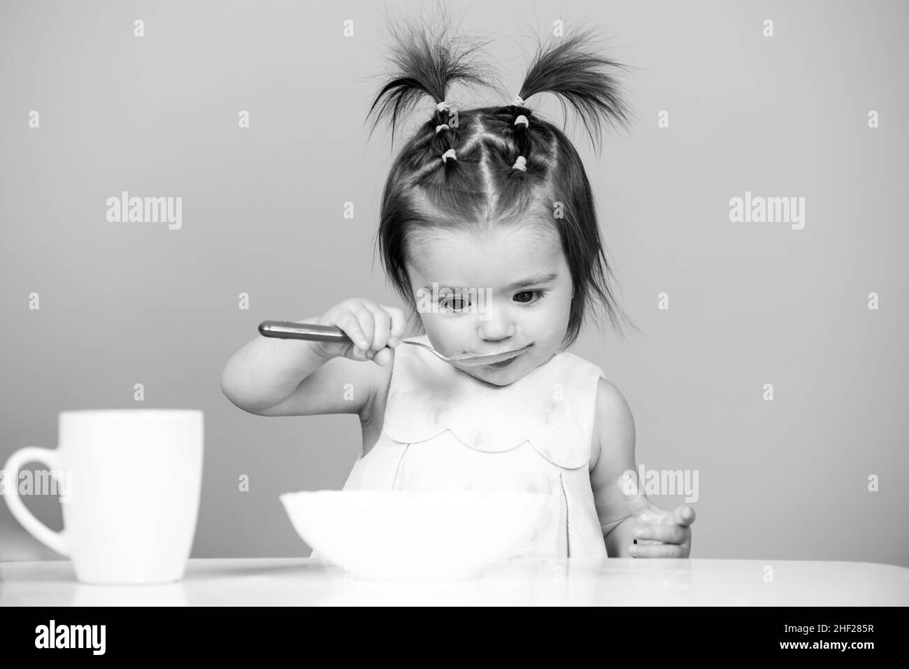 Portrait of cute Caucasian child kid with spoon. Hungry messy baby with ...