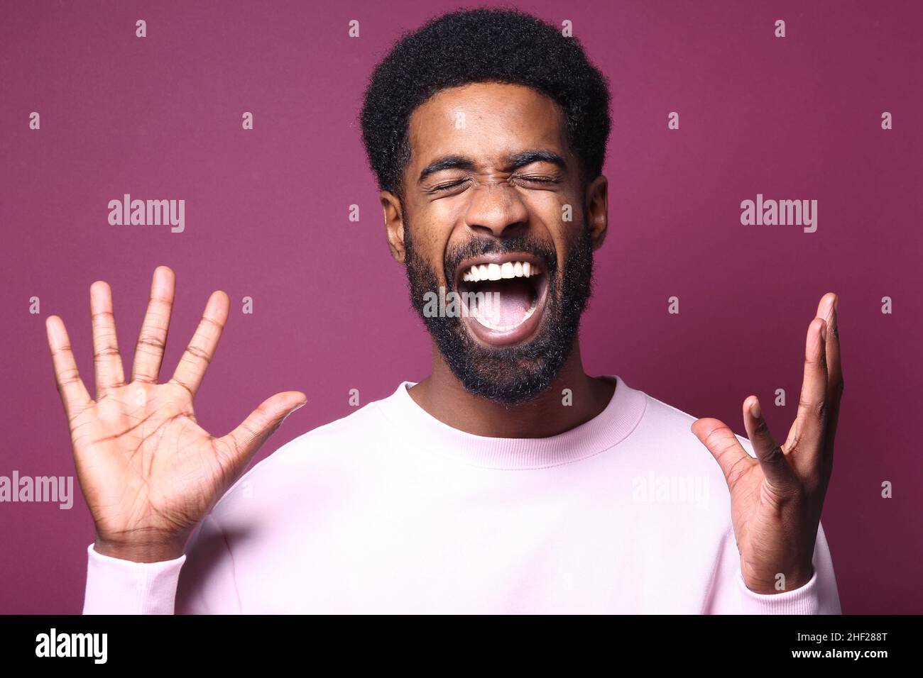 Portrait of a beautiful happy man in front of a colored background ...