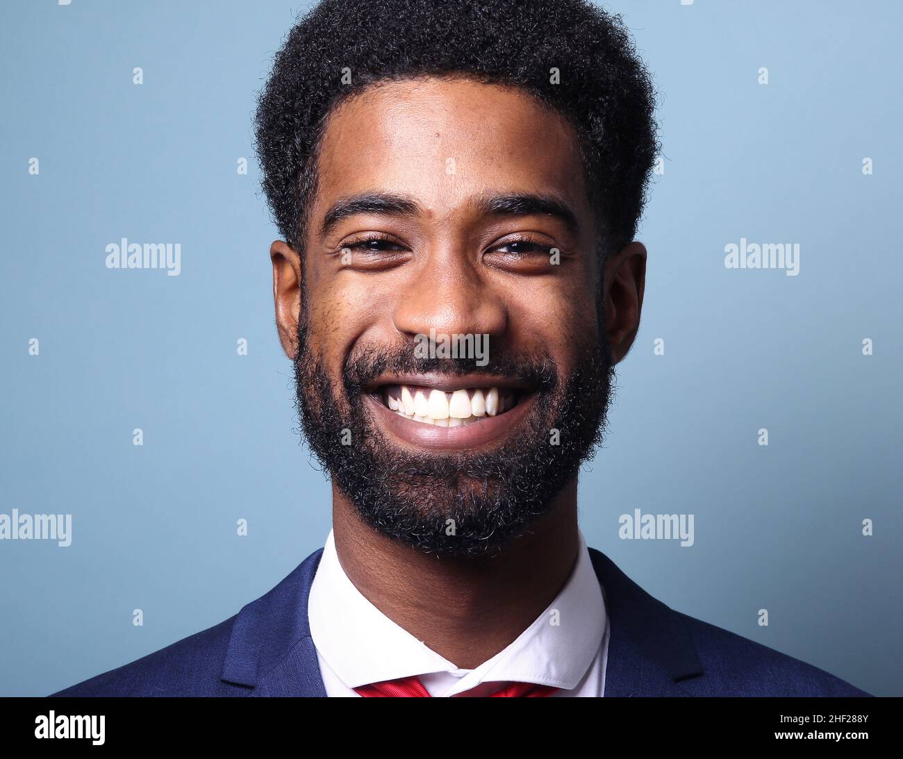 Portrait of a beautiful happy man in front of a colored background ...