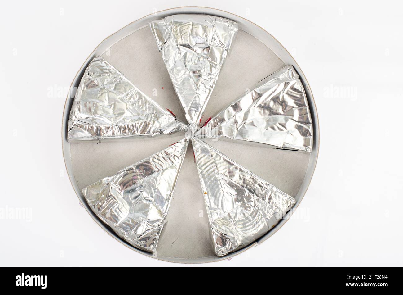 Cheese triangles in foil. Studio Photo Stock Photo - Alamy