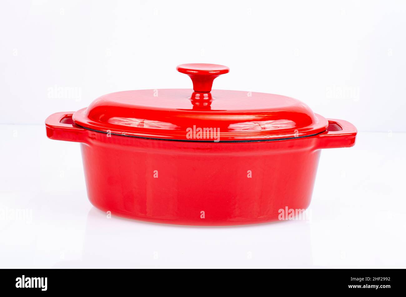 Red ceramic cast iron casserole dish. Studio Photo Stock Photo - Alamy