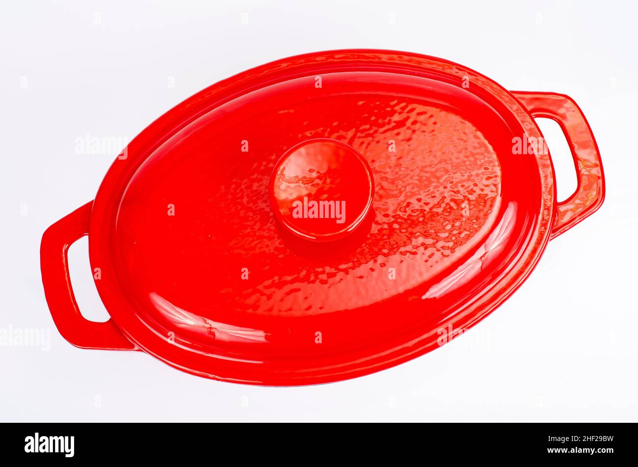 Red ceramic cast iron casserole dish. Studio Photo Stock Photo - Alamy