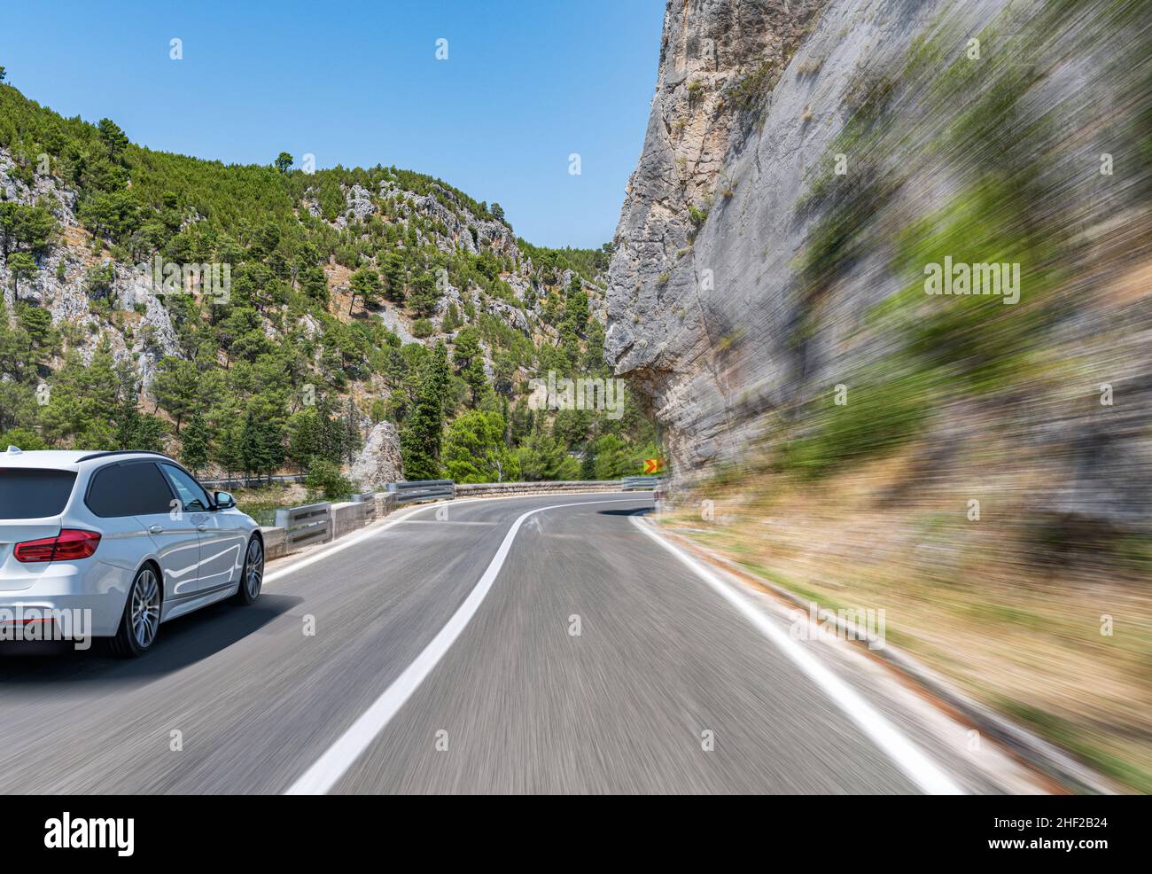 Car is driving along the road. White car on a suburban highway Stock ...