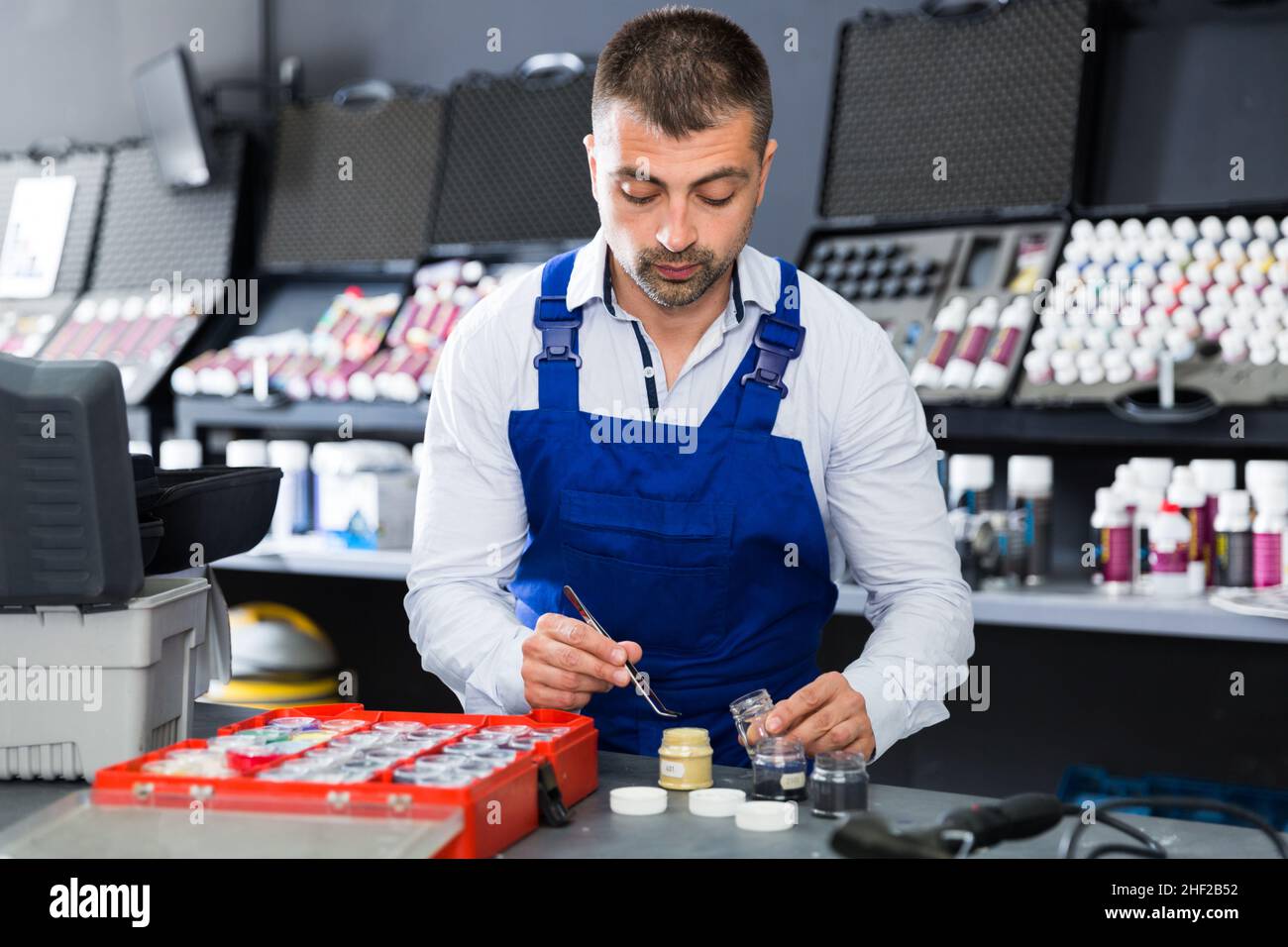 Mechanic selecting color for automobile upholstery Stock Photo - Alamy