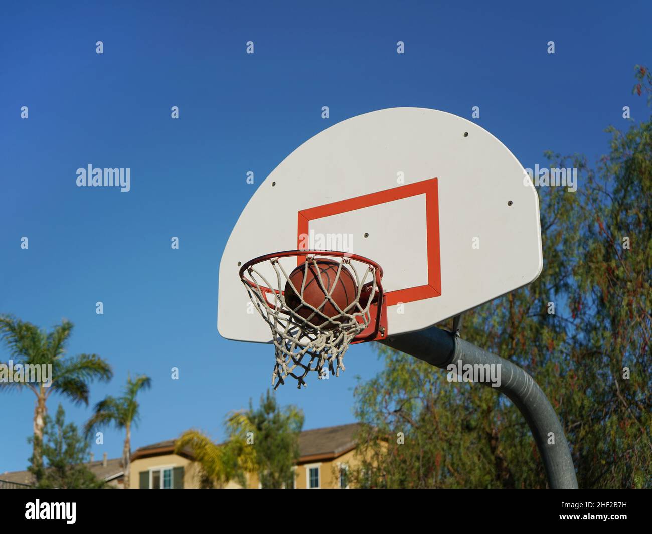 Low angle view of basketball passing through the net Stock Photo - Alamy