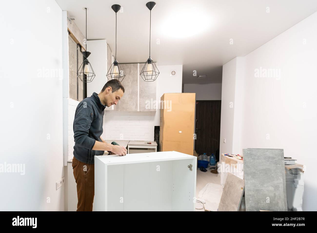 Worker installing new countertop in modern kitchen Stock Photo - Alamy