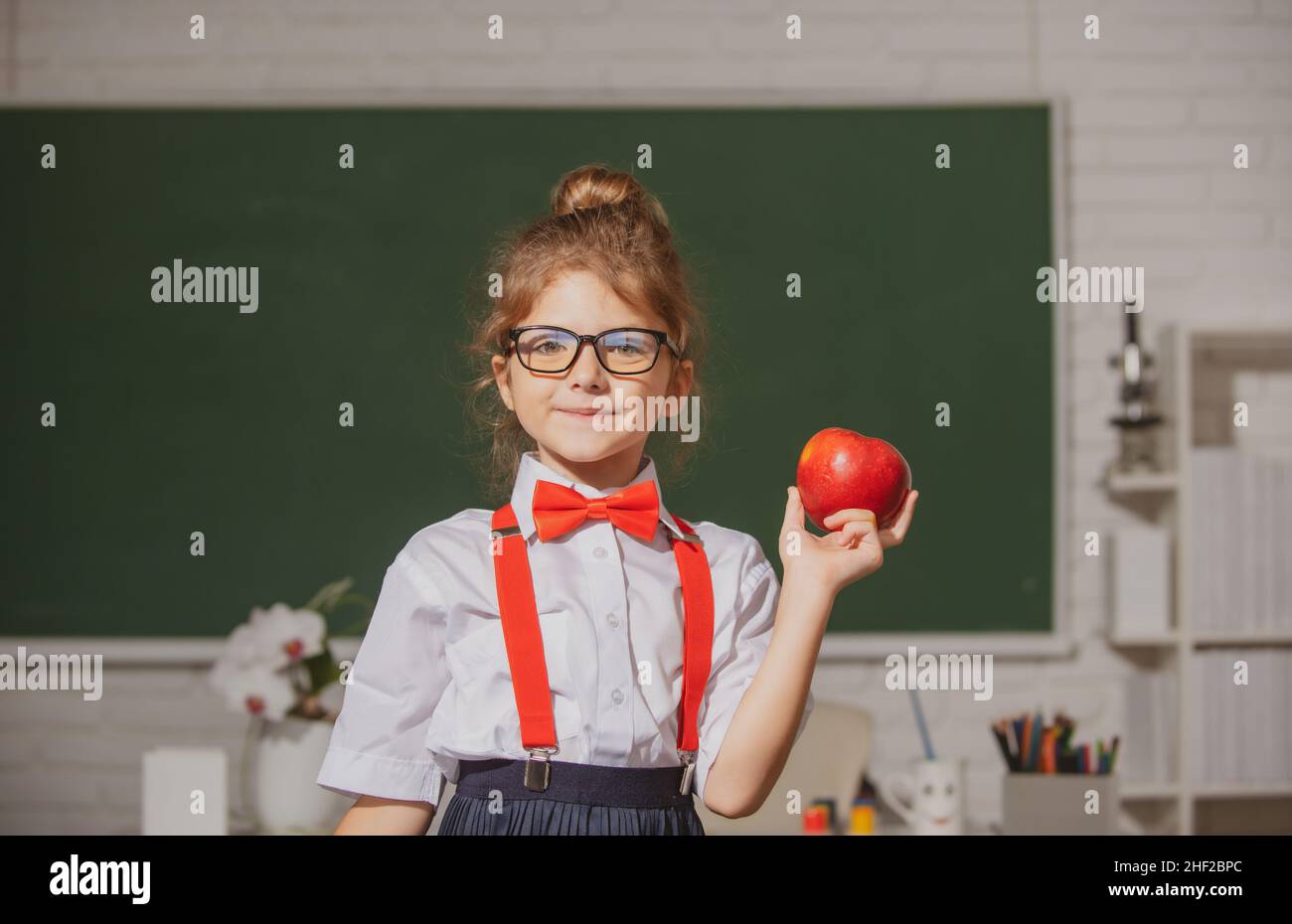 Cute child at school. Kid is learning in class on background of ...