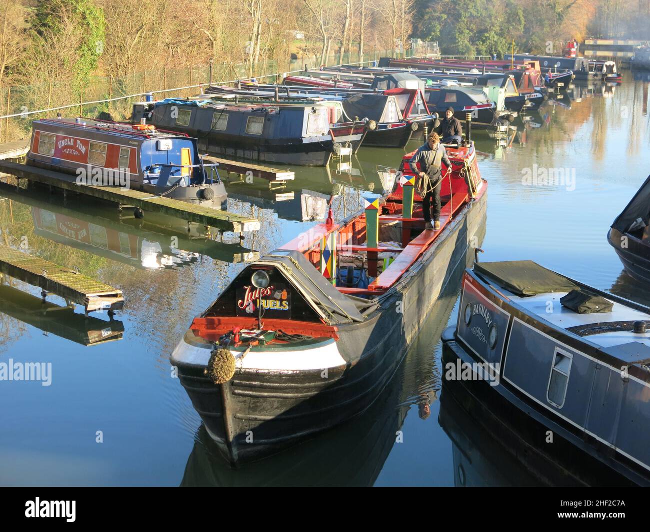 A working narrowboat laden with bags of coal delivers to the moored ...