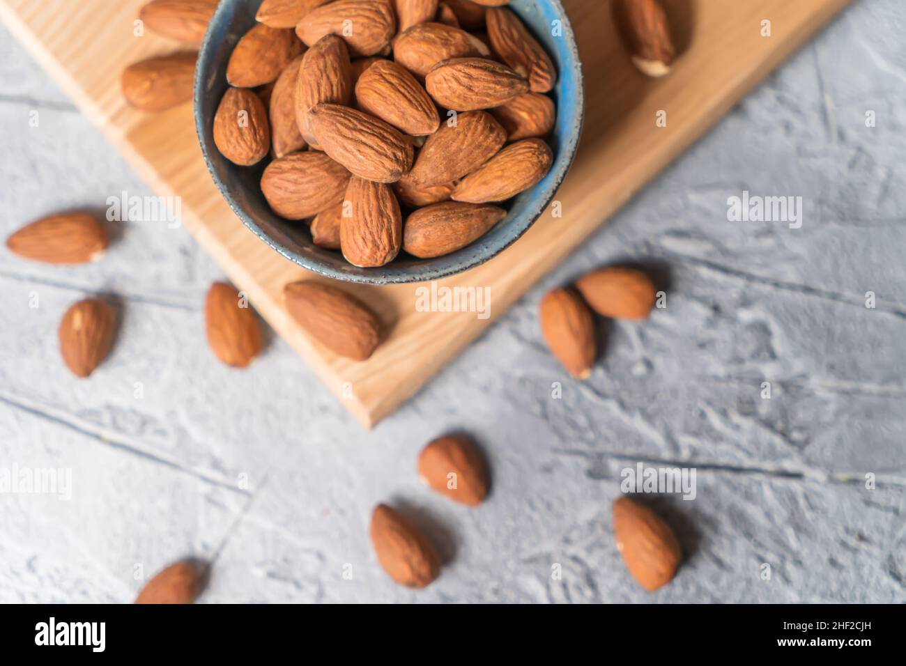 Almonds Nuts in bowl on table top view, copy space. Healthy natural ...