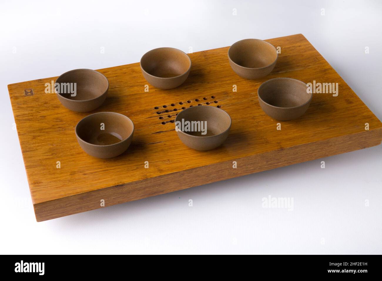 A set of six traditional cups for oriental tea drinking on a wooden ...