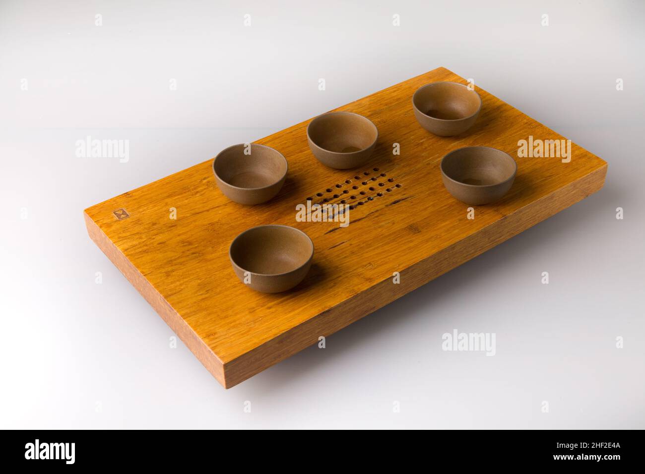 A set of five traditional cups for oriental tea drinking on a wooden ...