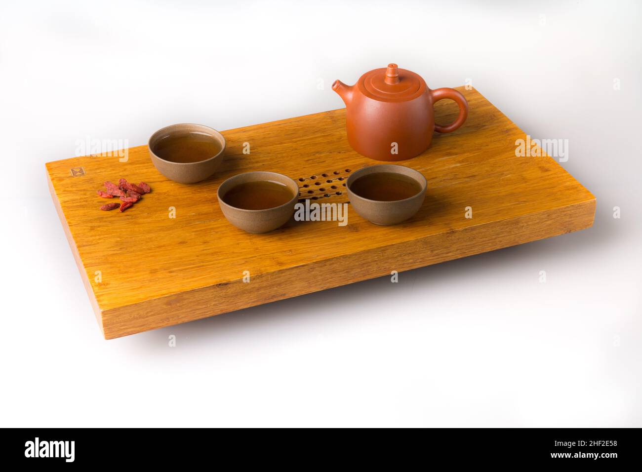 Ceramic teapot and three traditional cups for oriental tea drinking on ...