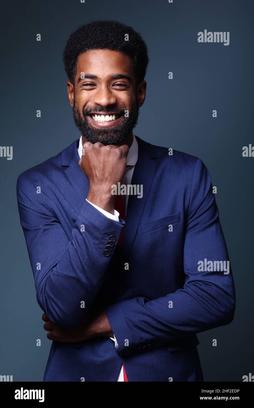 Portrait of a beautiful happy man in front of a colored background ...
