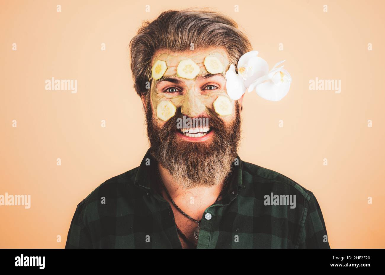 Funny man applied facial masks and cucumbers on face. Funny surprised ...