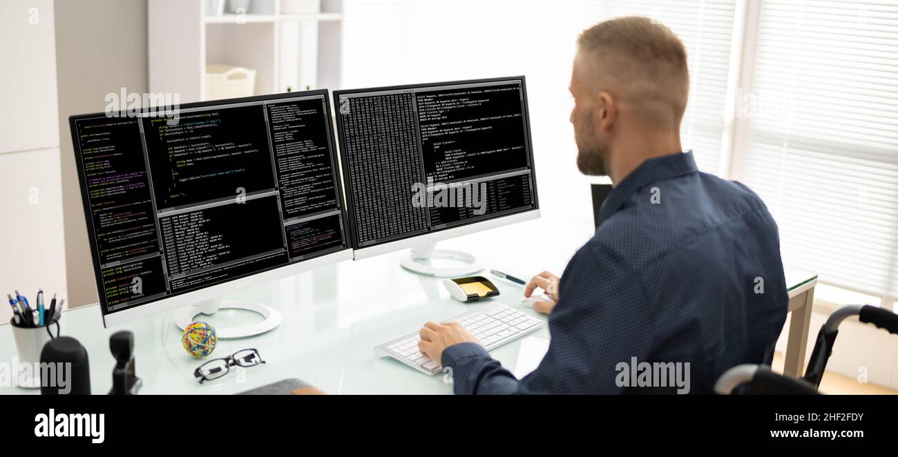 Coder In Wheelchair Using Computer. People In Office Stock Photo - Alamy