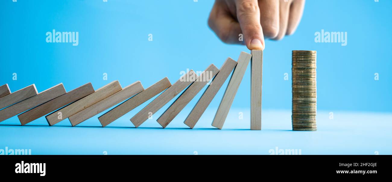 Stopping Domino Falling And Risk Prevention In Office Stock Photo - Alamy